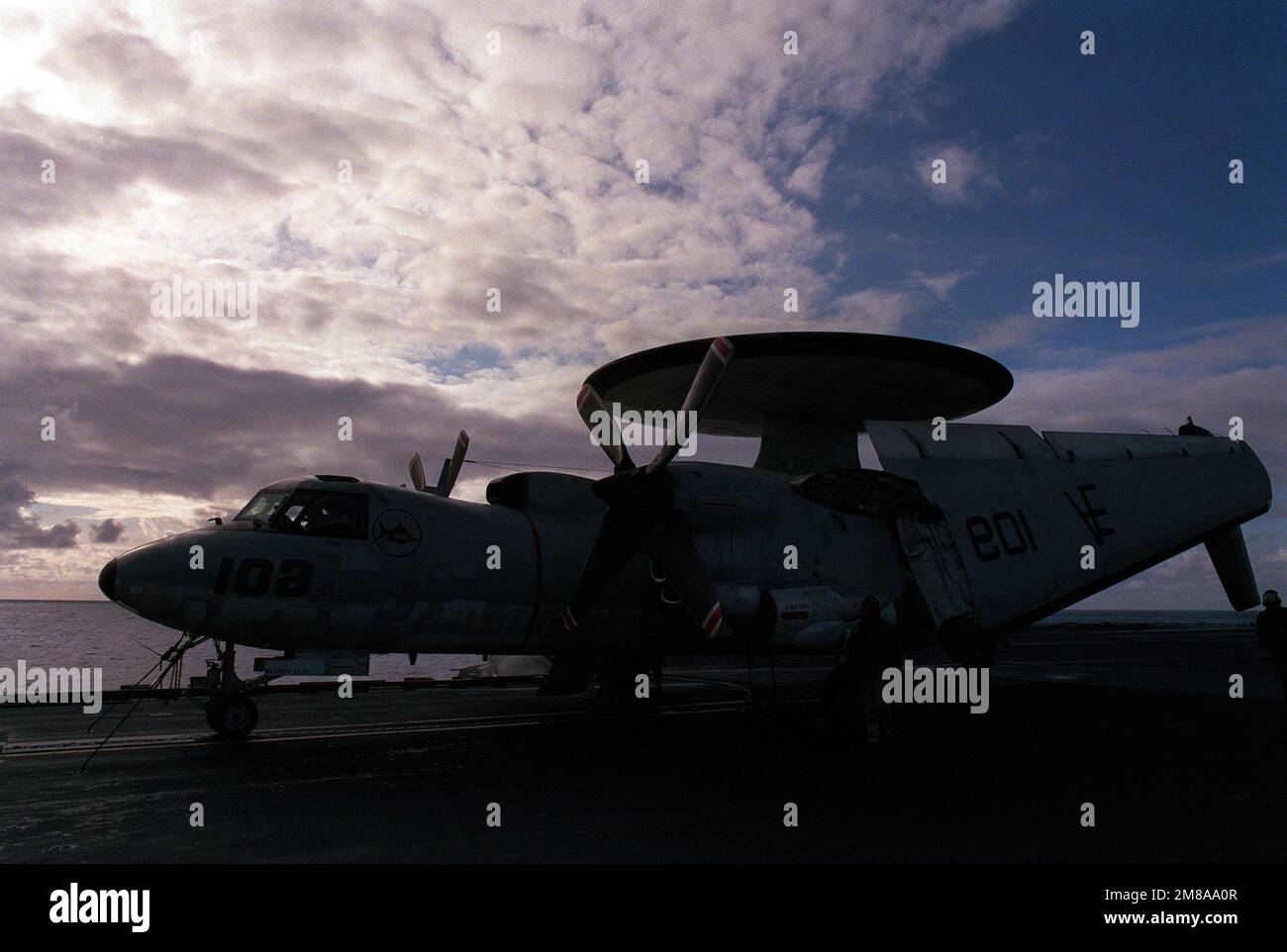 Crewmen stand beside an E-2C Hawkeye aircraft from Airborne Early ...