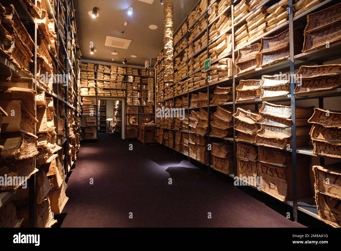 Interior gallery, displaying stacks of old bank ledger, yellowed, sepia ...