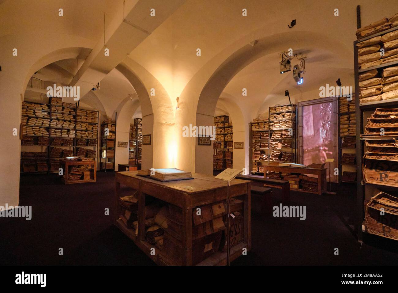 Interior gallery, displaying stacks of old bank ledger, yellowed, sepia ...