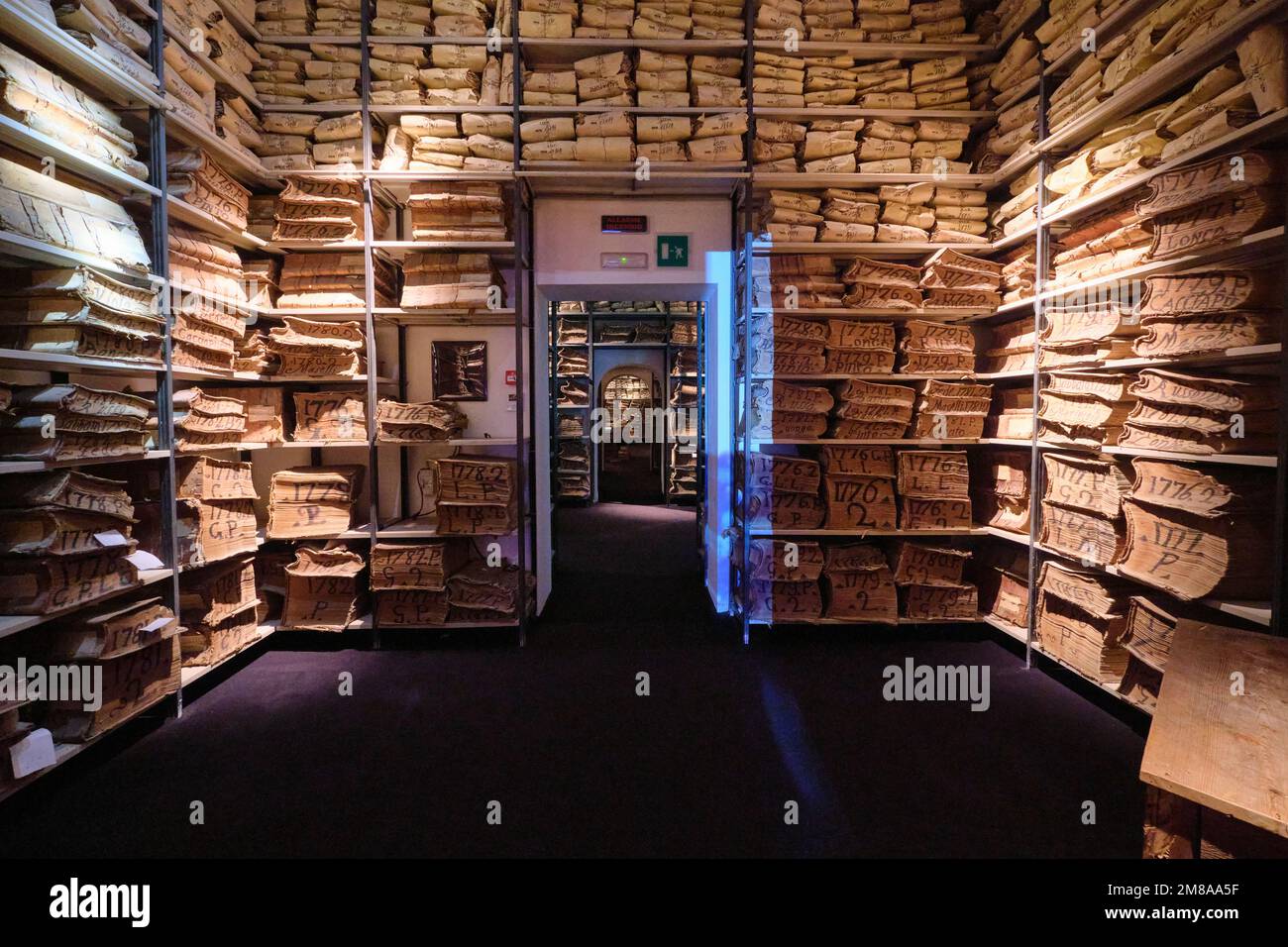 Interior gallery, displaying stacks of old bank ledger, yellowed, sepia ...
