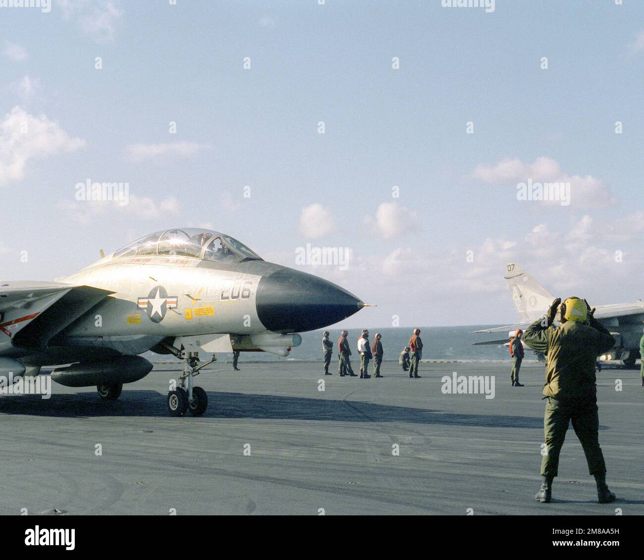 A Fighter Squadron 31 (VF-31) F-14A Tomcat aircraft is guided into ...