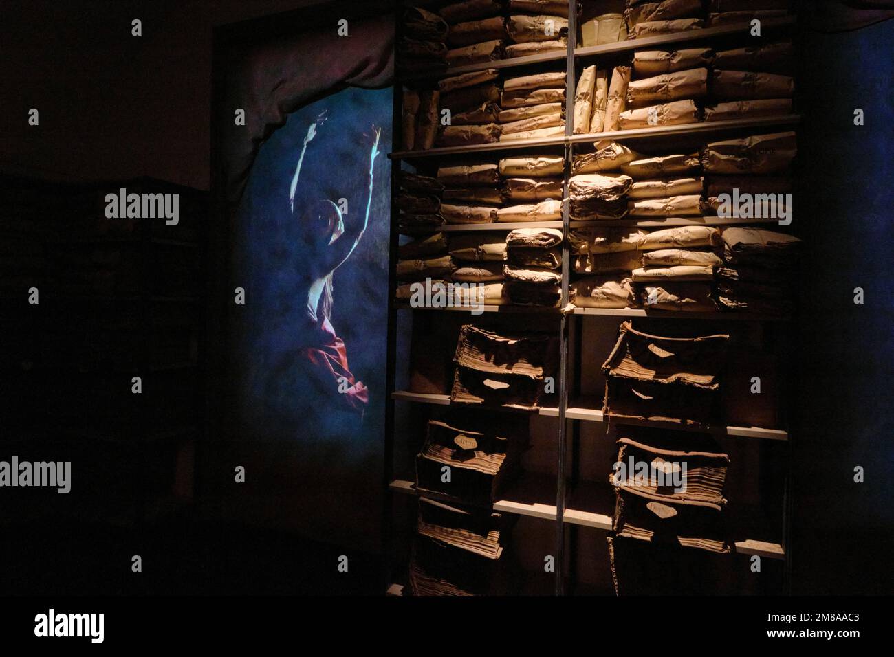 Interior gallery, displaying stacks of old bank ledger, yellowed, sepia ...