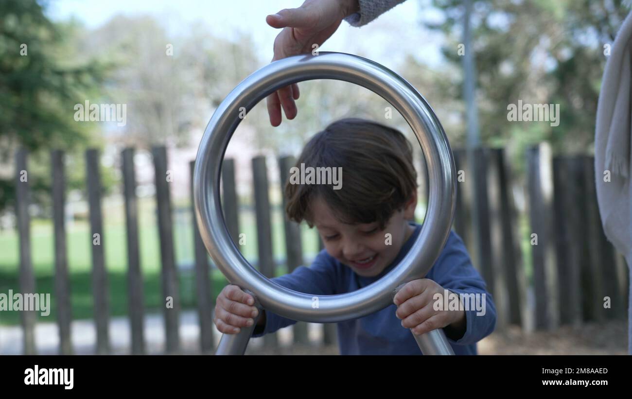 Child spinning at playground spinner structure. One little boy having ...