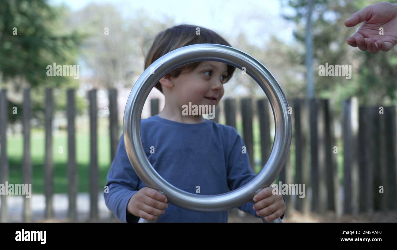 Child spinning at playground spinner structure. One little boy having ...