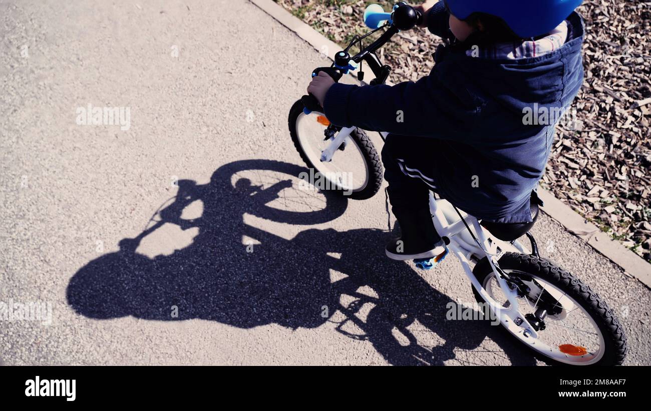 Child riding bicycle. Top view perspective of kid shadow outdoors Stock ...