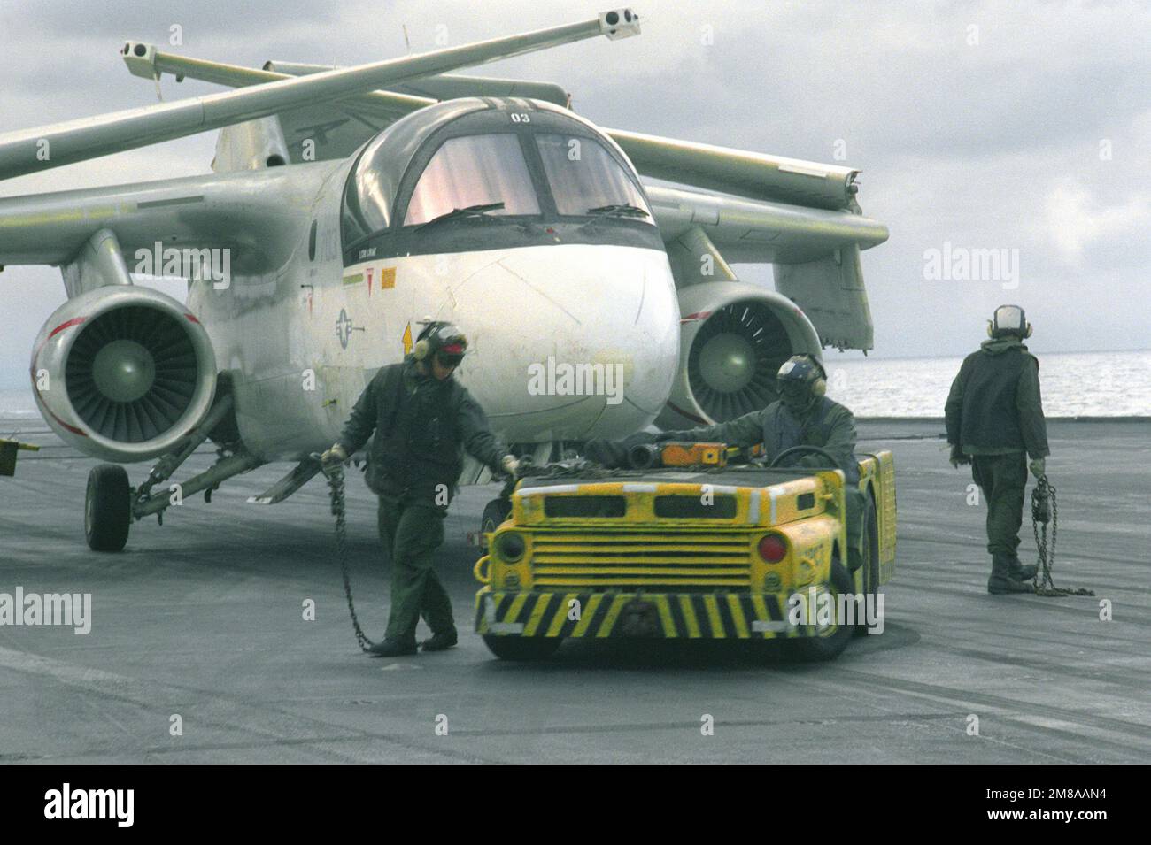 Aircraft handlers use an MD-3A tow tractor to move an Air Anti ...