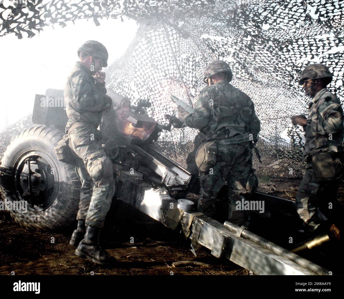 Personnel from the 37th Field Artillery fire an M-102 105mm howitzer ...