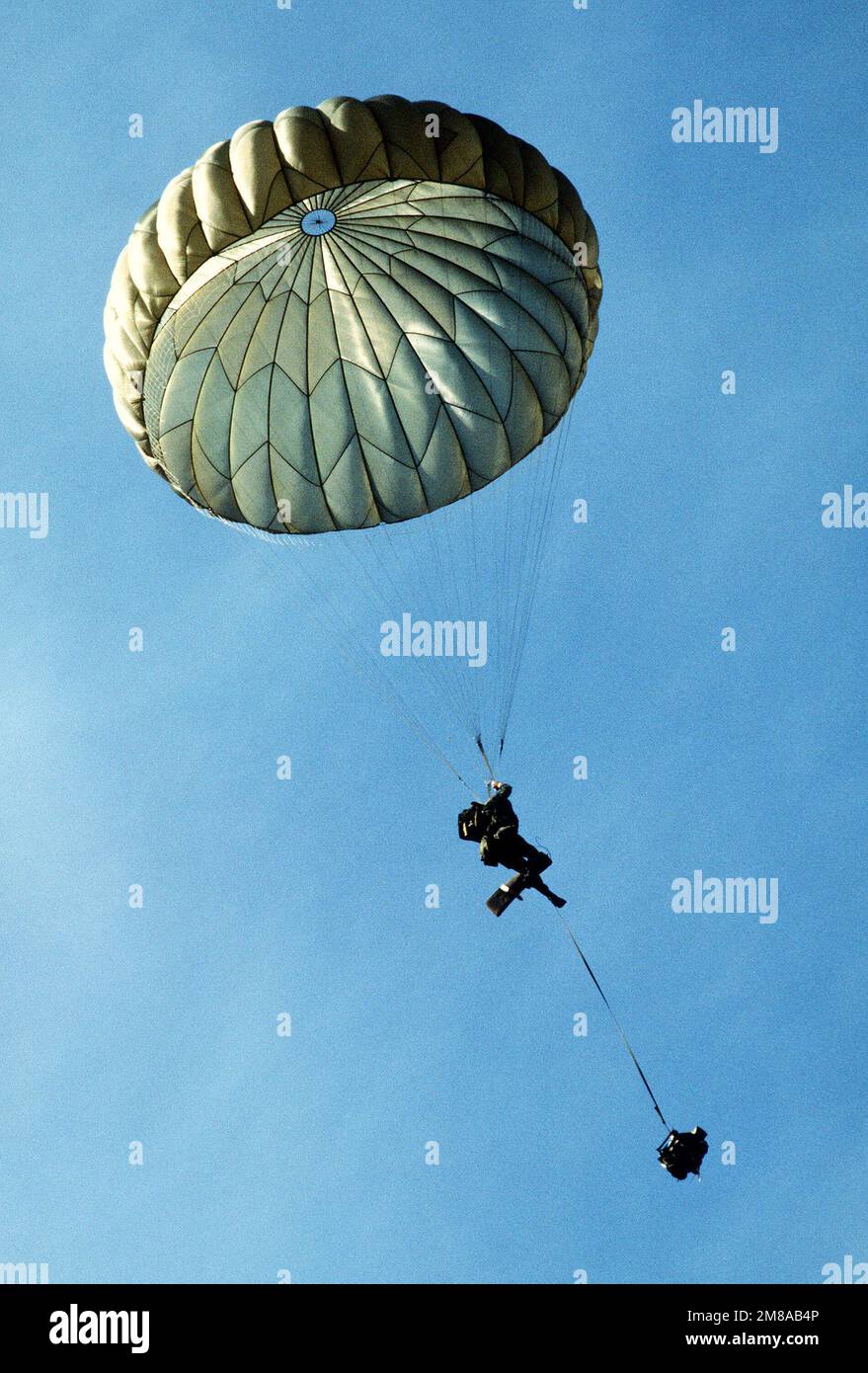 A paratrooper descends with his chute fully deployed, during combined ...