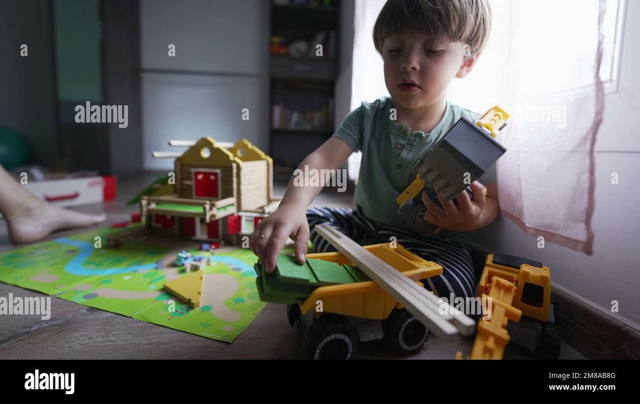 One little boy playing in playroom at home. Childhood development plays ...