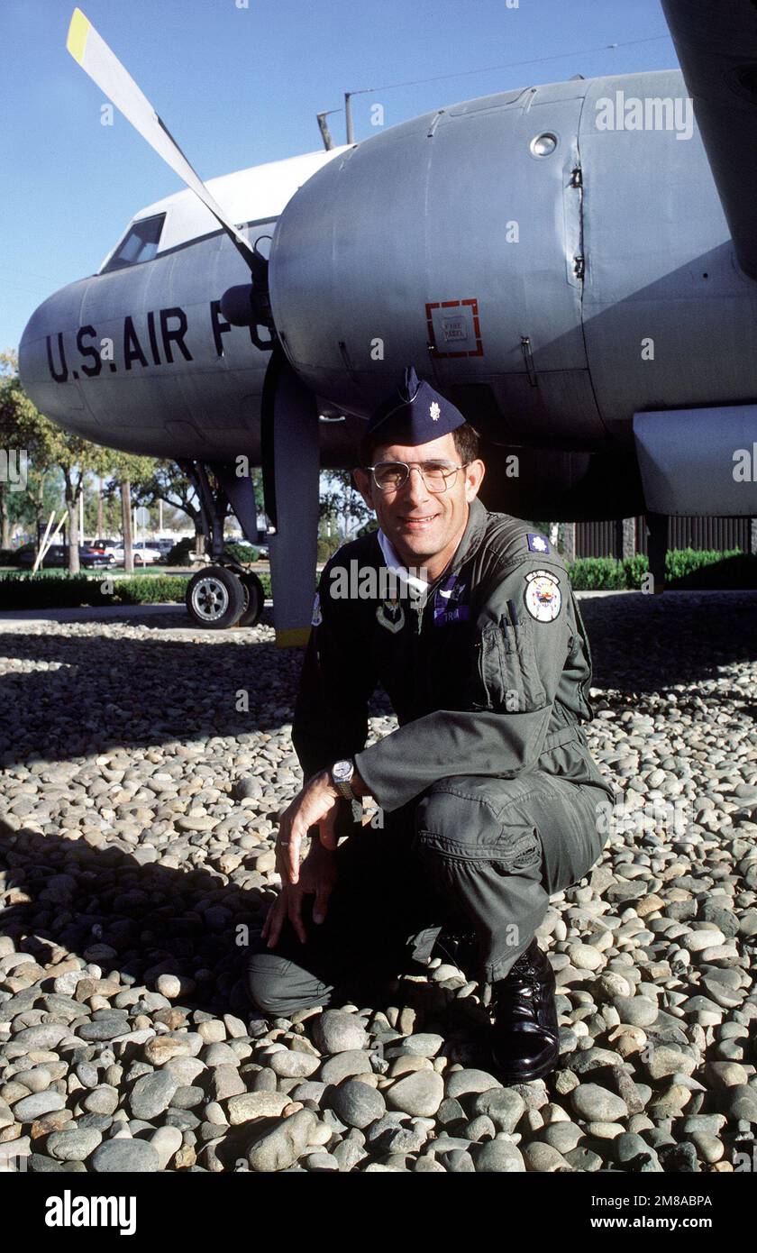 Operations officer LT. COL. Thomas N. Trotta kneels in front of a T-29 ...