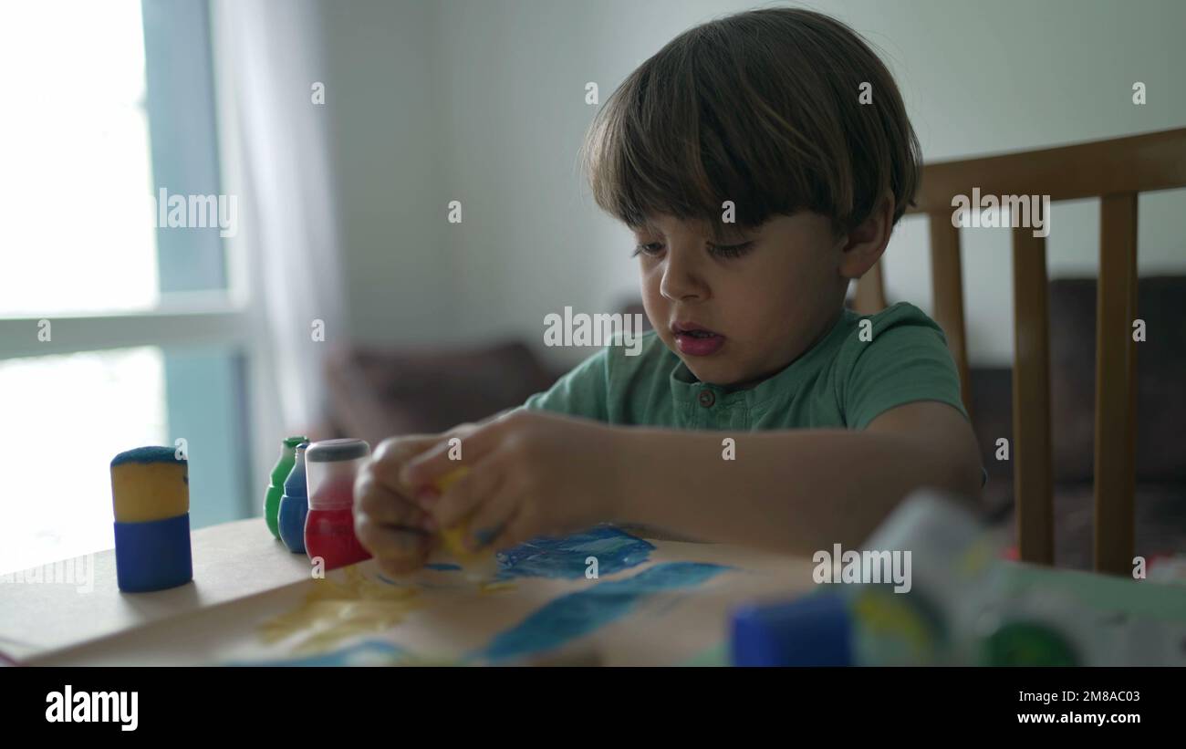 Child paint creativity activity at home. Artistic little boy painting ...