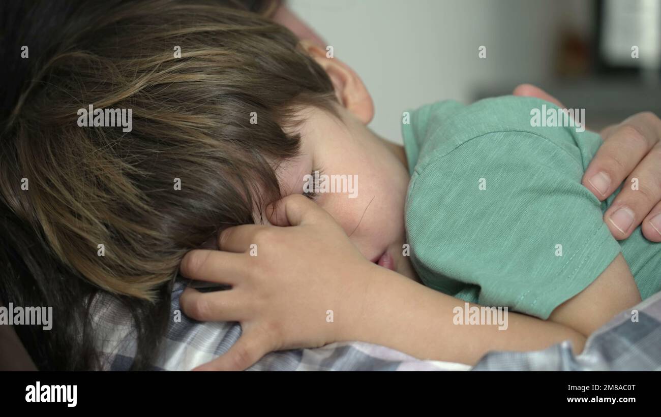 Sad tearful little boy crying. Child leaning on mother shoulder feeling ...