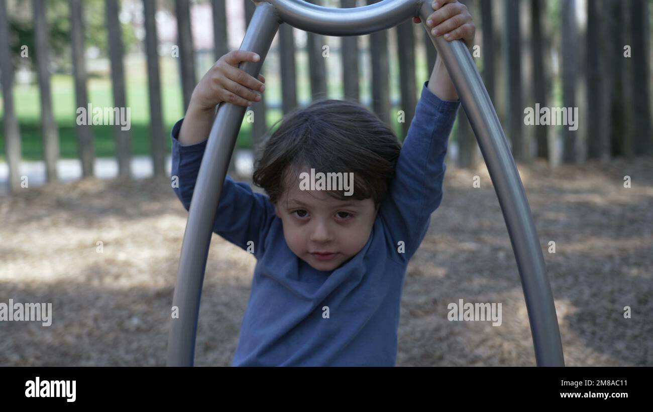 Child spinning at playground spinner structure. One little boy having ...