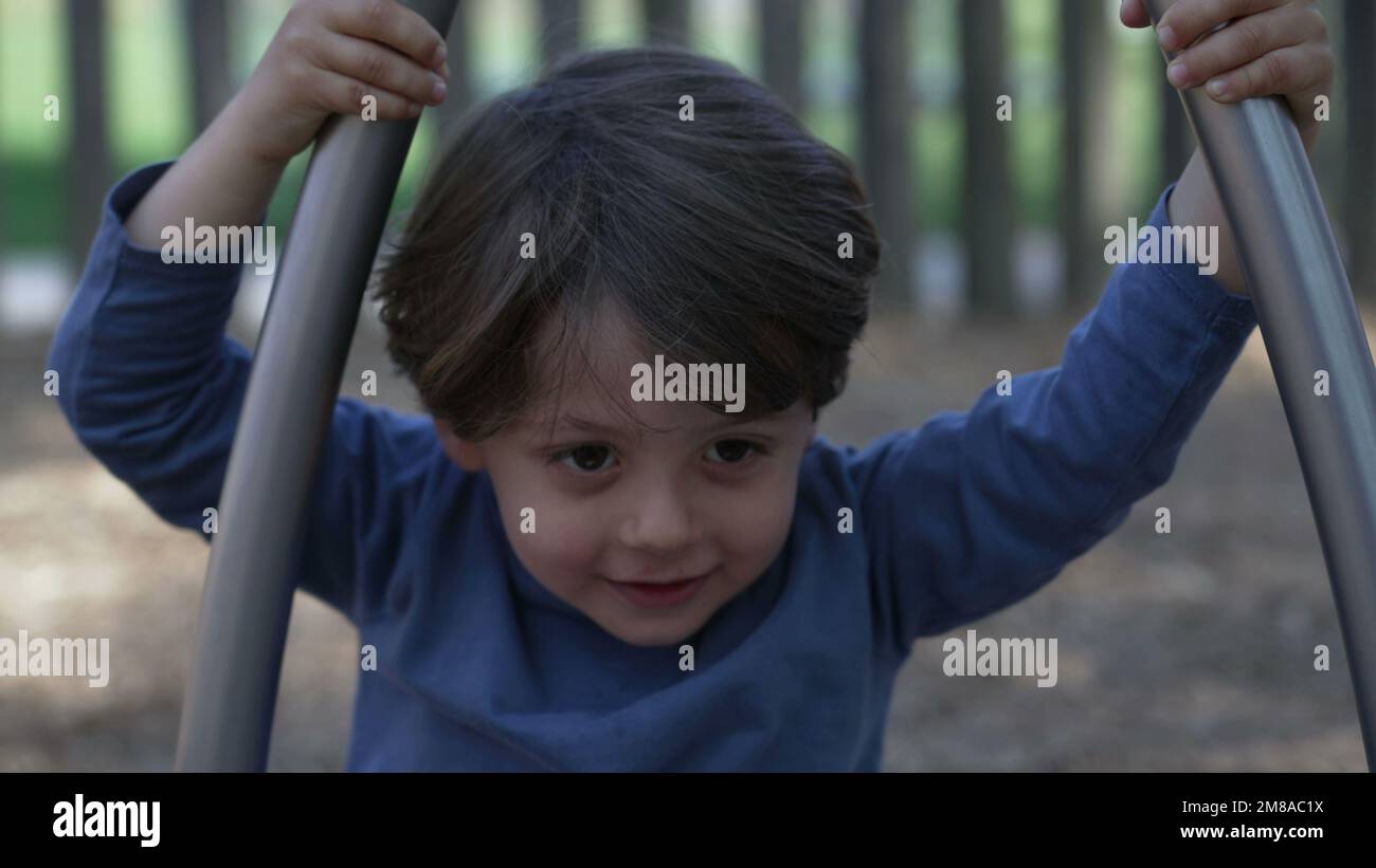Child spinning at playground spinner structure. One little boy having ...