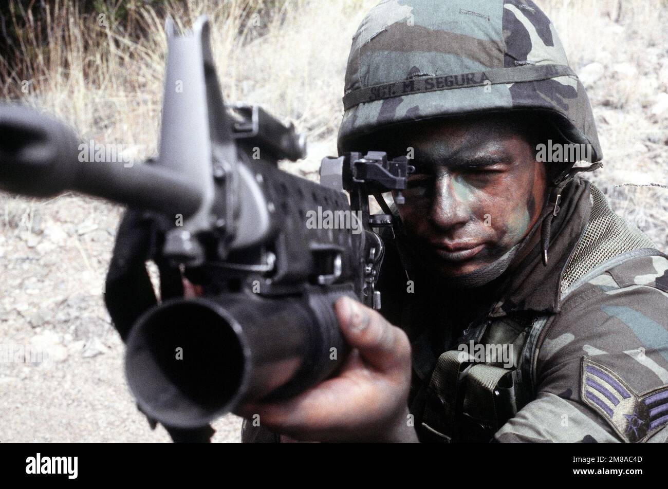 STAFF SGT. Manuel Segura, Space Command, aims an M-16A1 rifle equipped ...