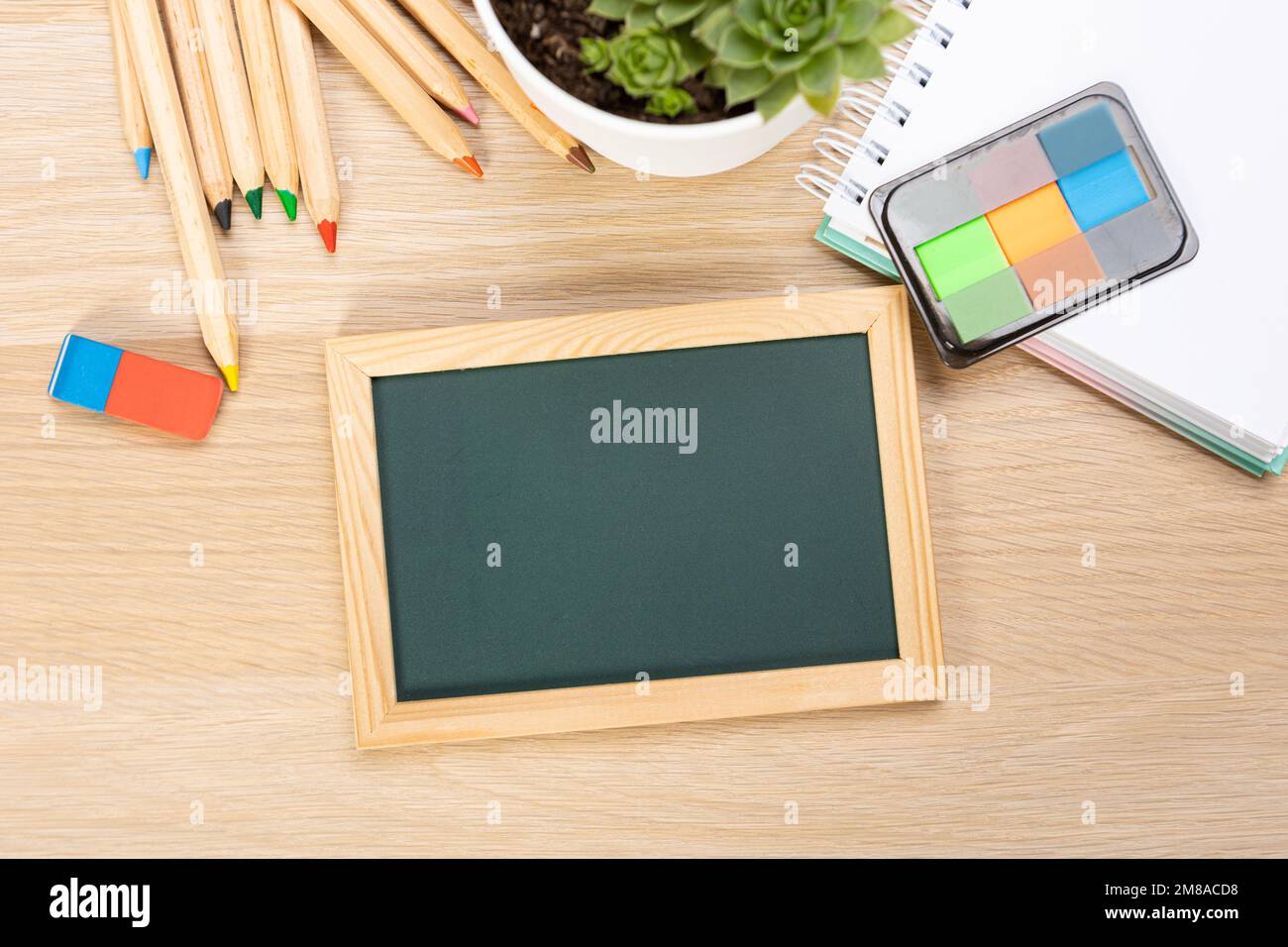 School chalkboard mockup on work desk. Composition of a student's desk ...