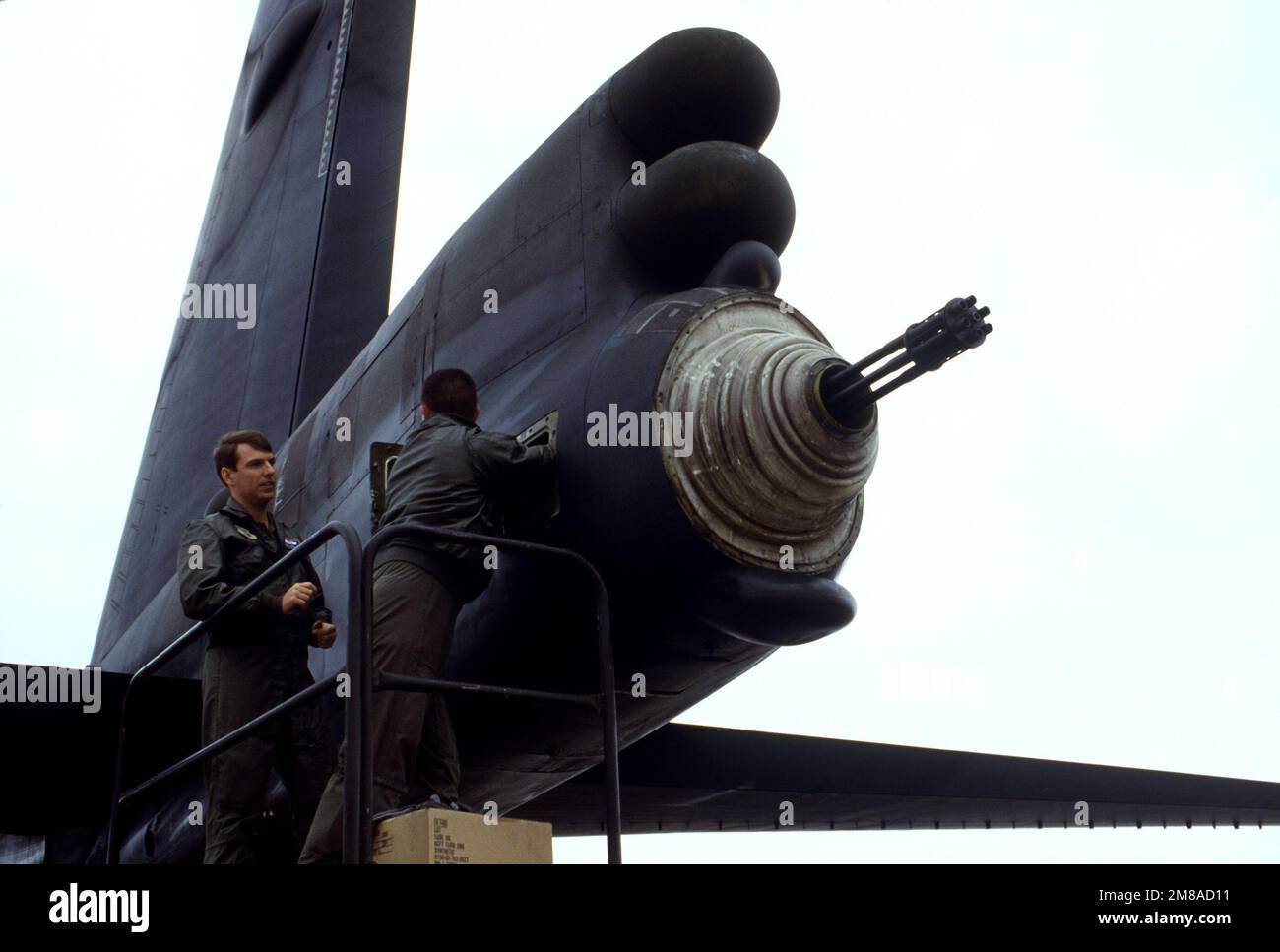 Air crew members service the Vulcan 20mm multi-barrel cannon in the ...