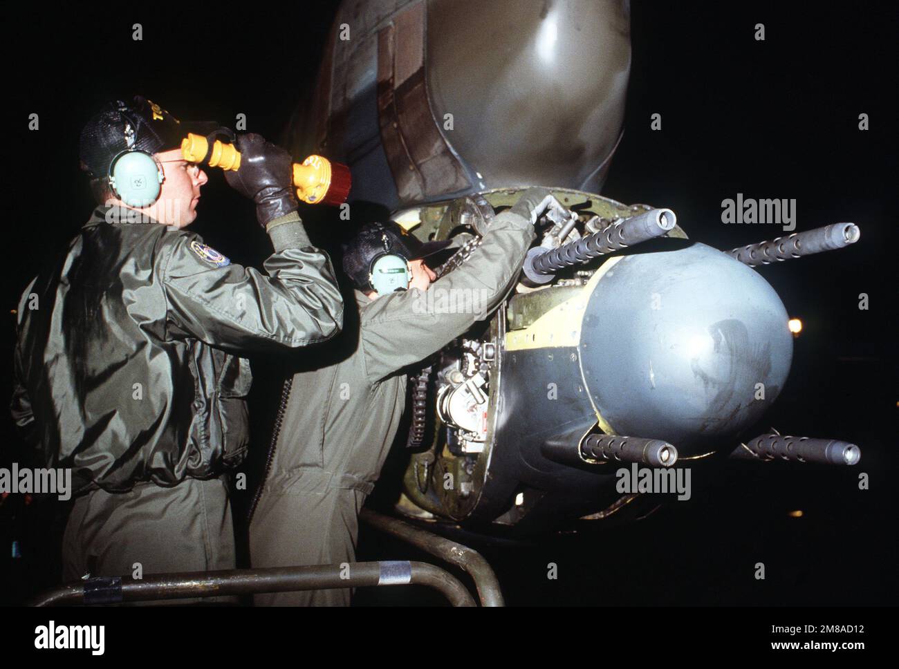 Aircrewmen inspect the .50-caliber machine guns in the tail turret of a ...