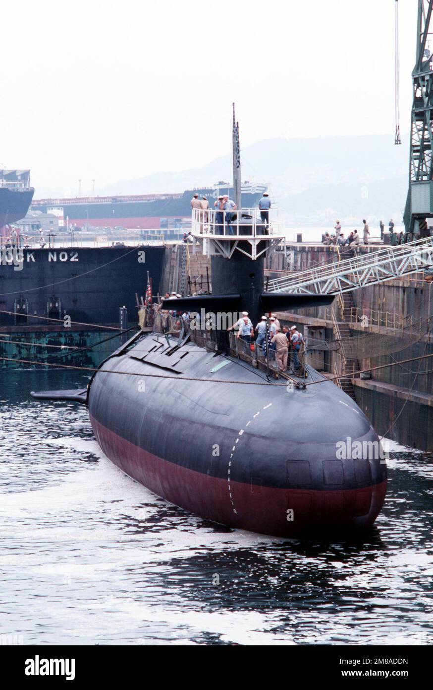 Crew members stand at the railing of the attack submarine USS BARBEL ...