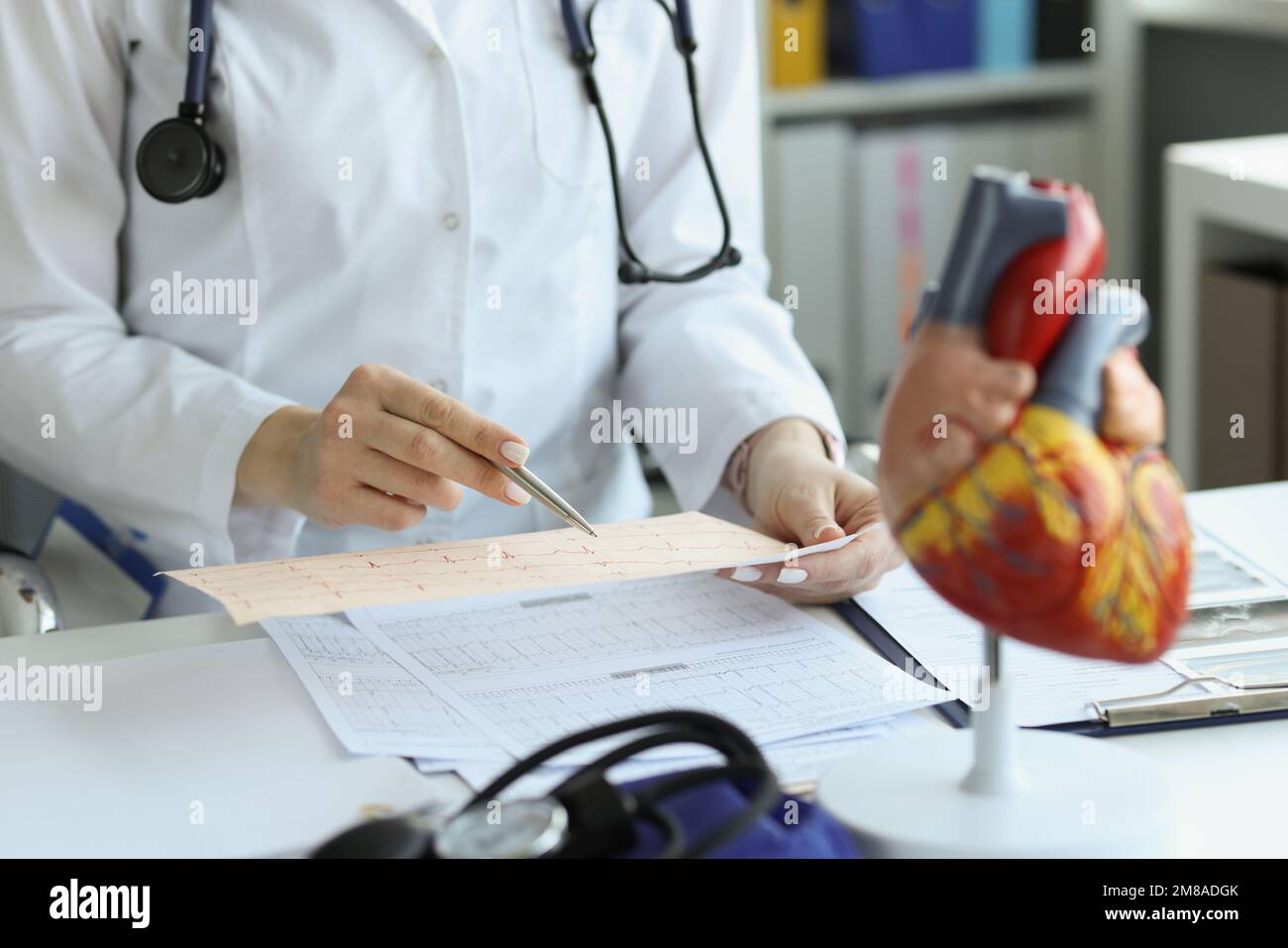 Cardiologist Doctor Holding And Reading An Ecg Paper Report Of Patient