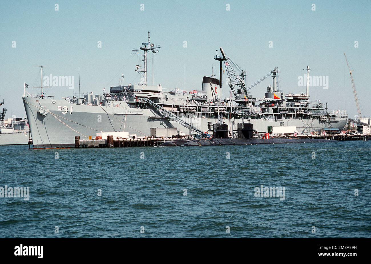 A port bow view of the submarine tender USS HUNLEY (AS-31) moored at ...