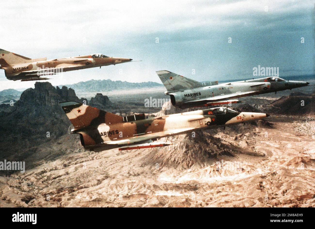 An air-to-air right side view of three Israeli-built F-21 Kfir aircraft with the new Marine ...