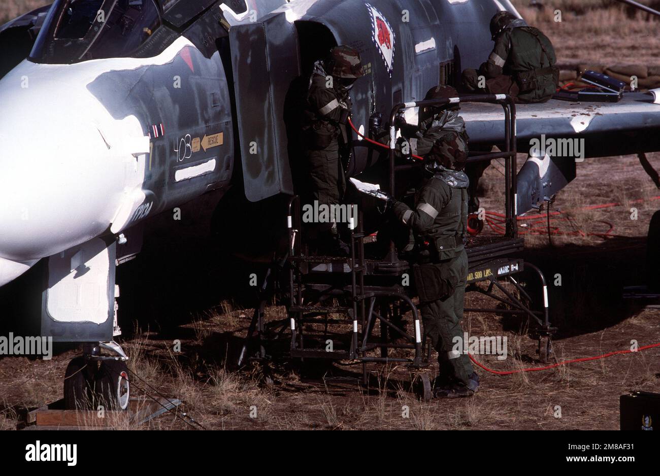 Members of a combat logistics support squadron assess damage to an F-4 ...