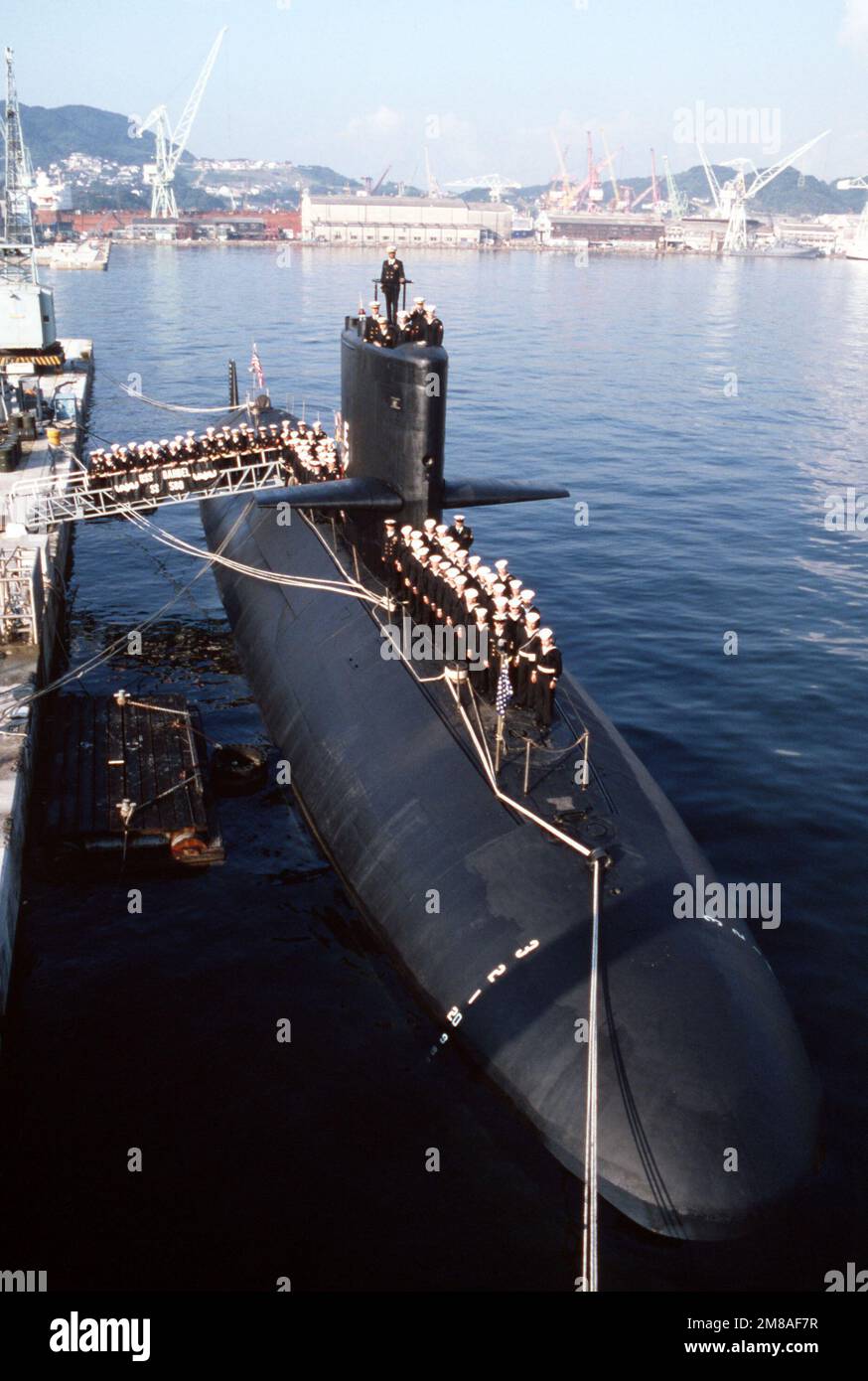 Crew members man the rails aboard the attack submarine USS BARBEL (SS ...