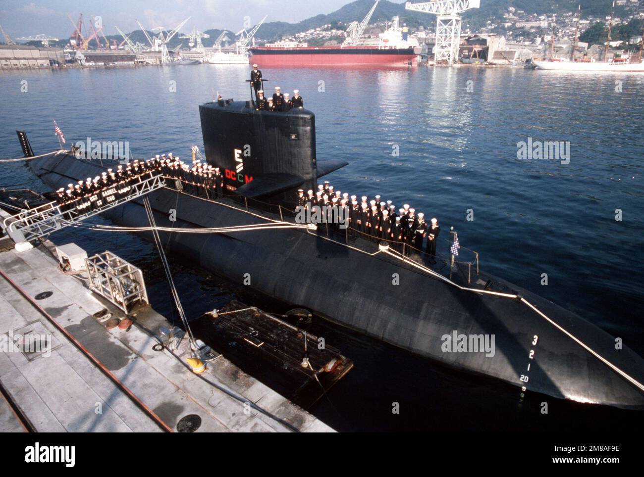 Crew members man the rails aboard the attack submarine USS BARBEL (SS ...