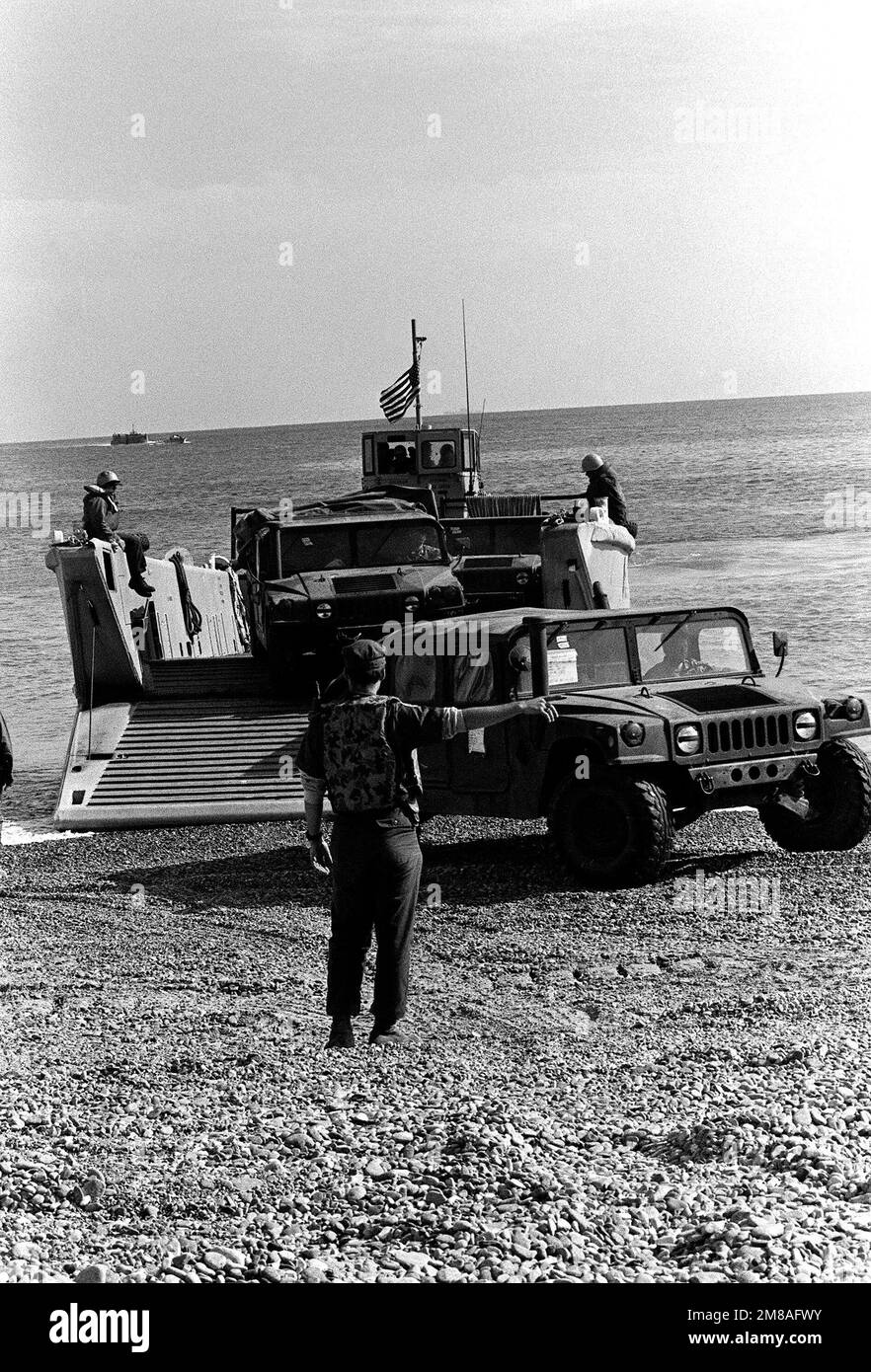 M998 High-Mobility Multipurpose Wheeled Vehicles (HMMWV) are offloaded ...