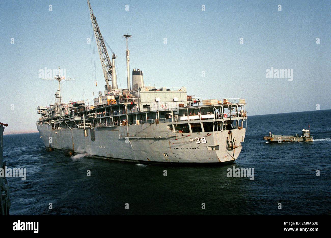 A port quarter view of the submarine tender USS EMORY S. LAND (AS-39 ...