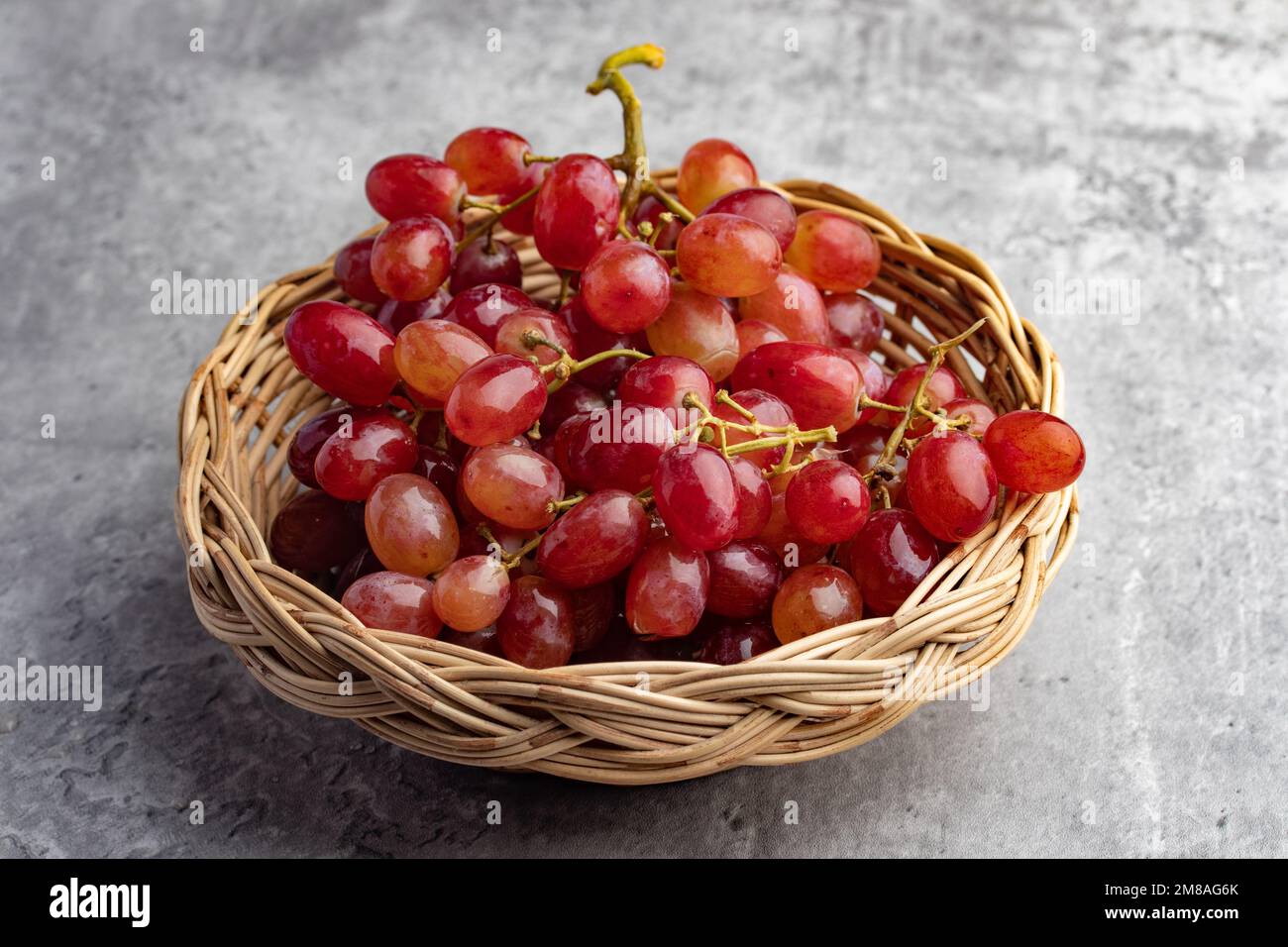 fresh red grapes on a gray background Stock Photo - Alamy