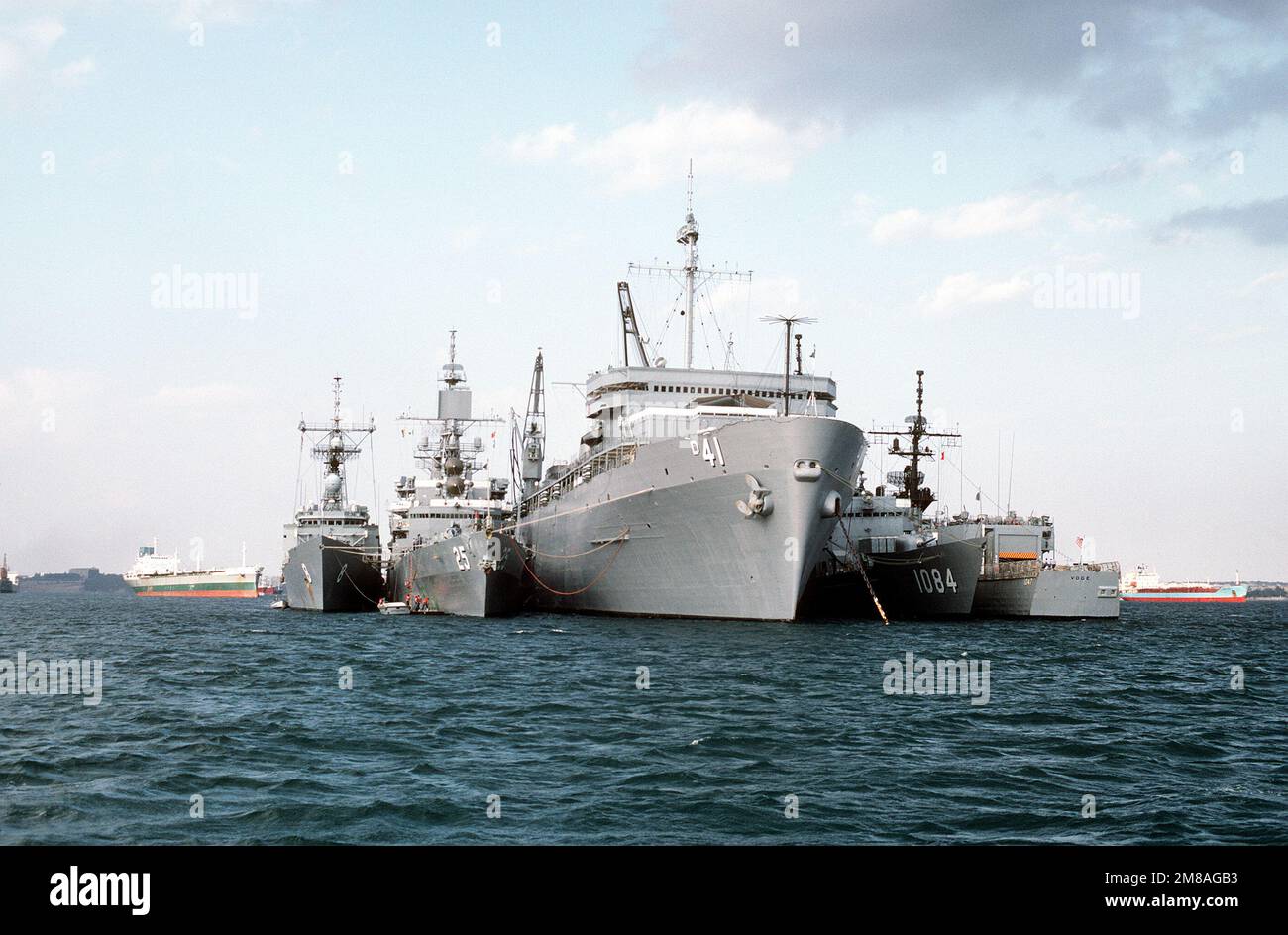 The destroyer tender USS YELLOWSTONE (AD-41) services, from left: the ...