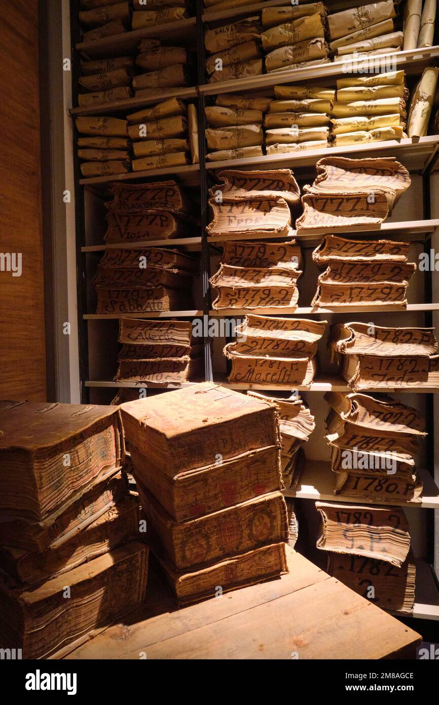 Interior gallery, displaying stacks of old bank ledger, yellowed, sepia ...