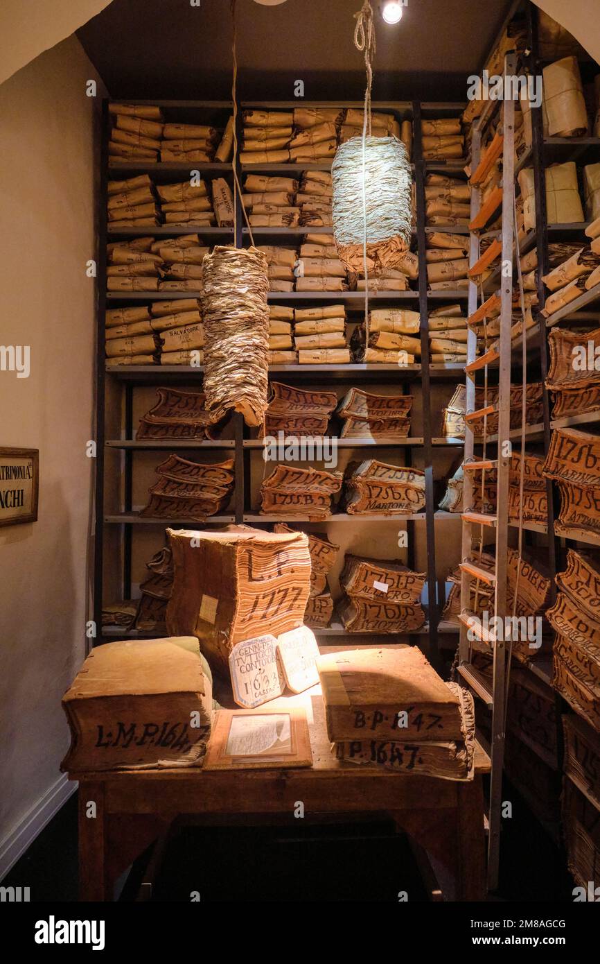 Interior gallery, displaying stacks of old bank ledger, yellowed, sepia ...