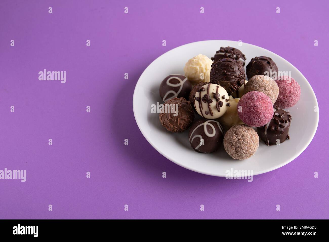 photo of candy in a chocolate shell lying next to each other on a plate ...