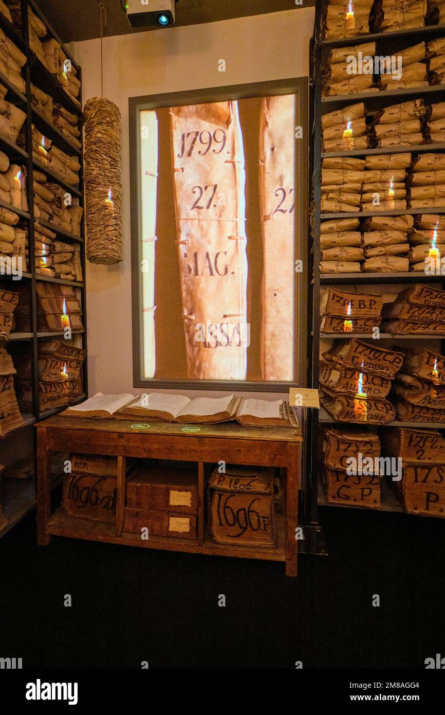 Interior gallery, displaying stacks of old bank ledger, yellowed, sepia ...