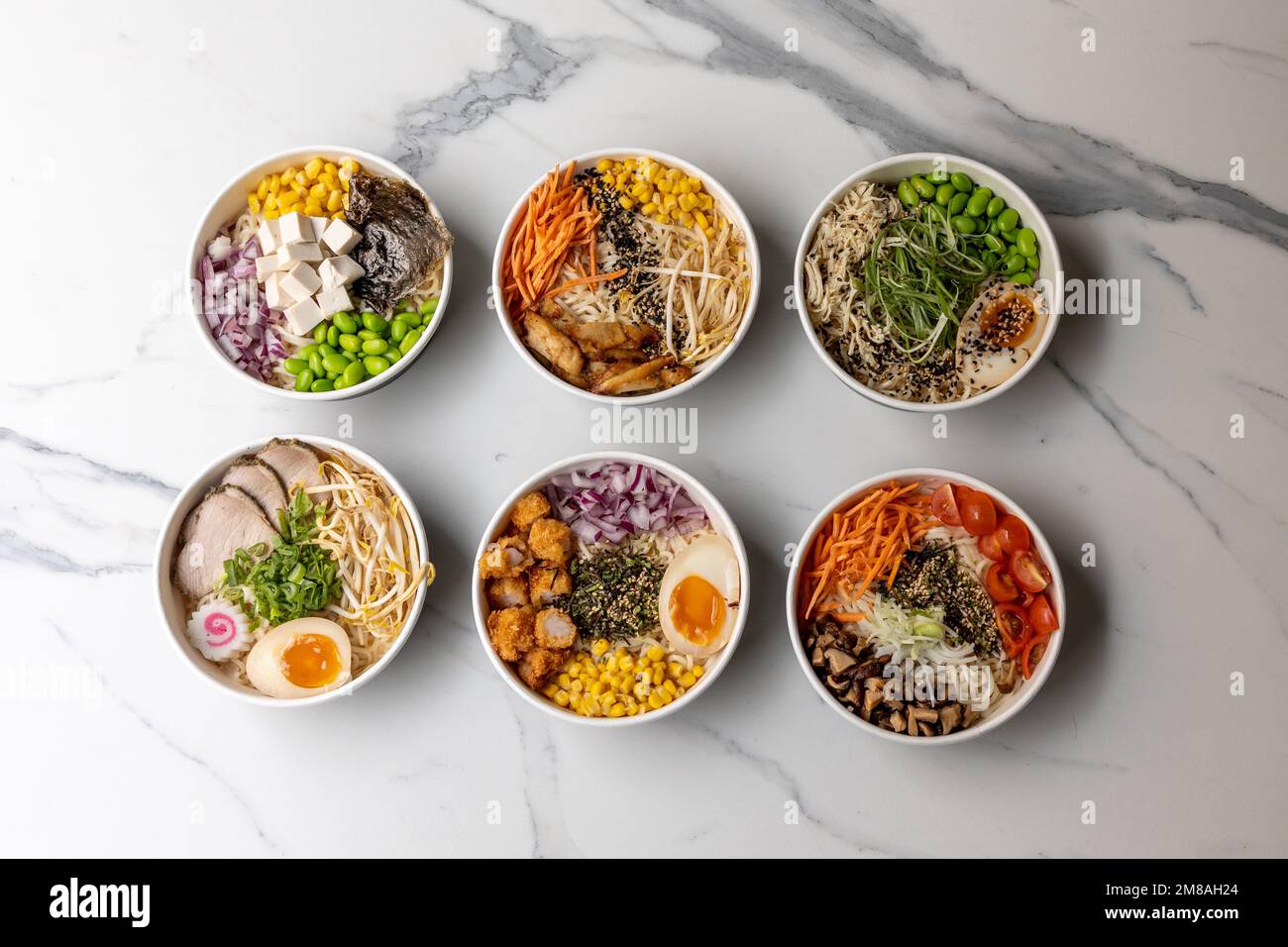 A top view of delicious poke bowls on the marble table Stock Photo - Alamy
