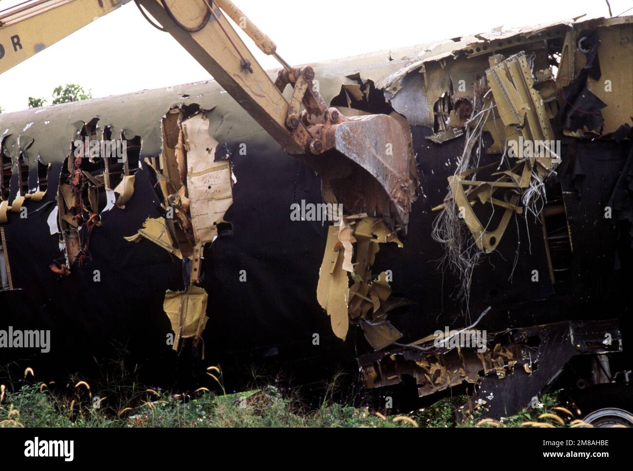 A ditch digging machine tears at the fuselage of a B-52D Stratofortress ...