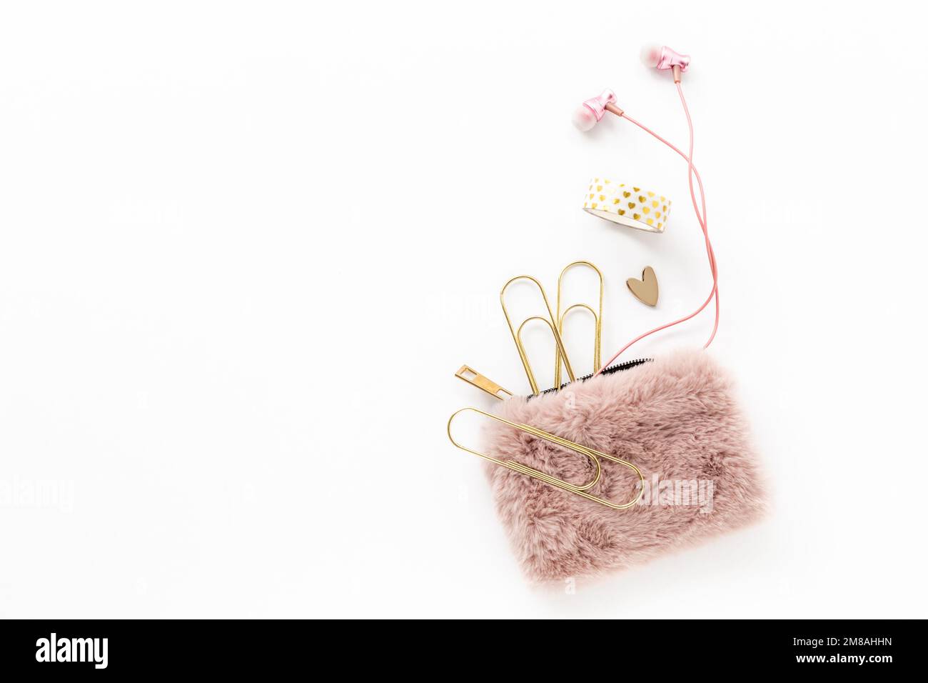 Feminine gold and pink items including stationery, earbuds, purse ...