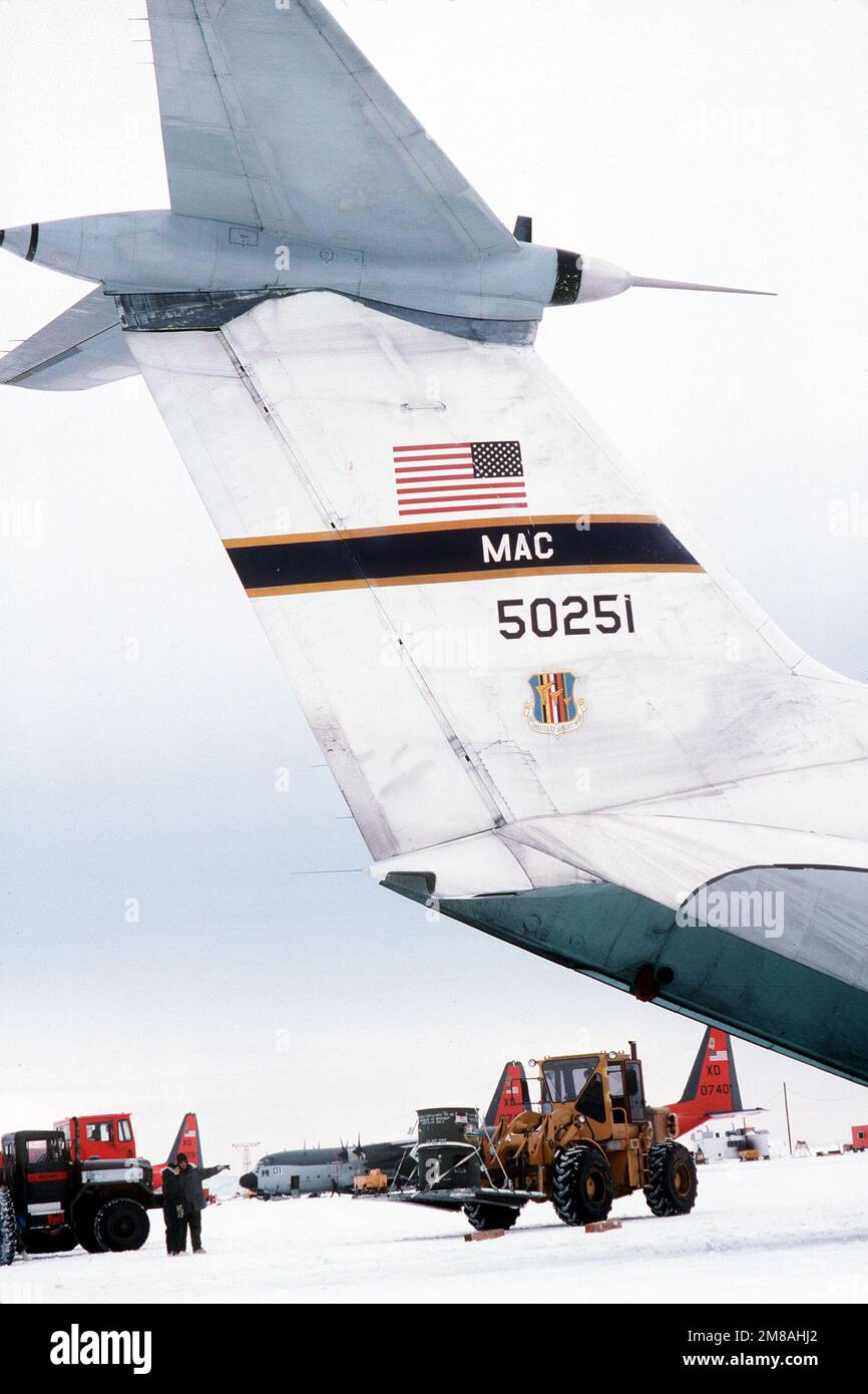 A forklift moving a 55-gallon drum passes under the tail section of a ...