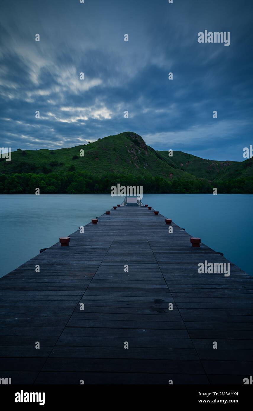 Vertical long exposure shot of jetty at Loh Buaya on Rinca Island ...