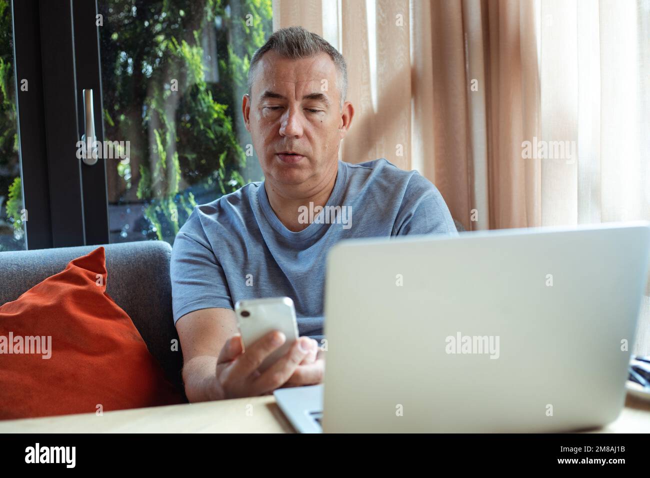 Serious, busy tired, overworked grizzled man using mobile phone and ...