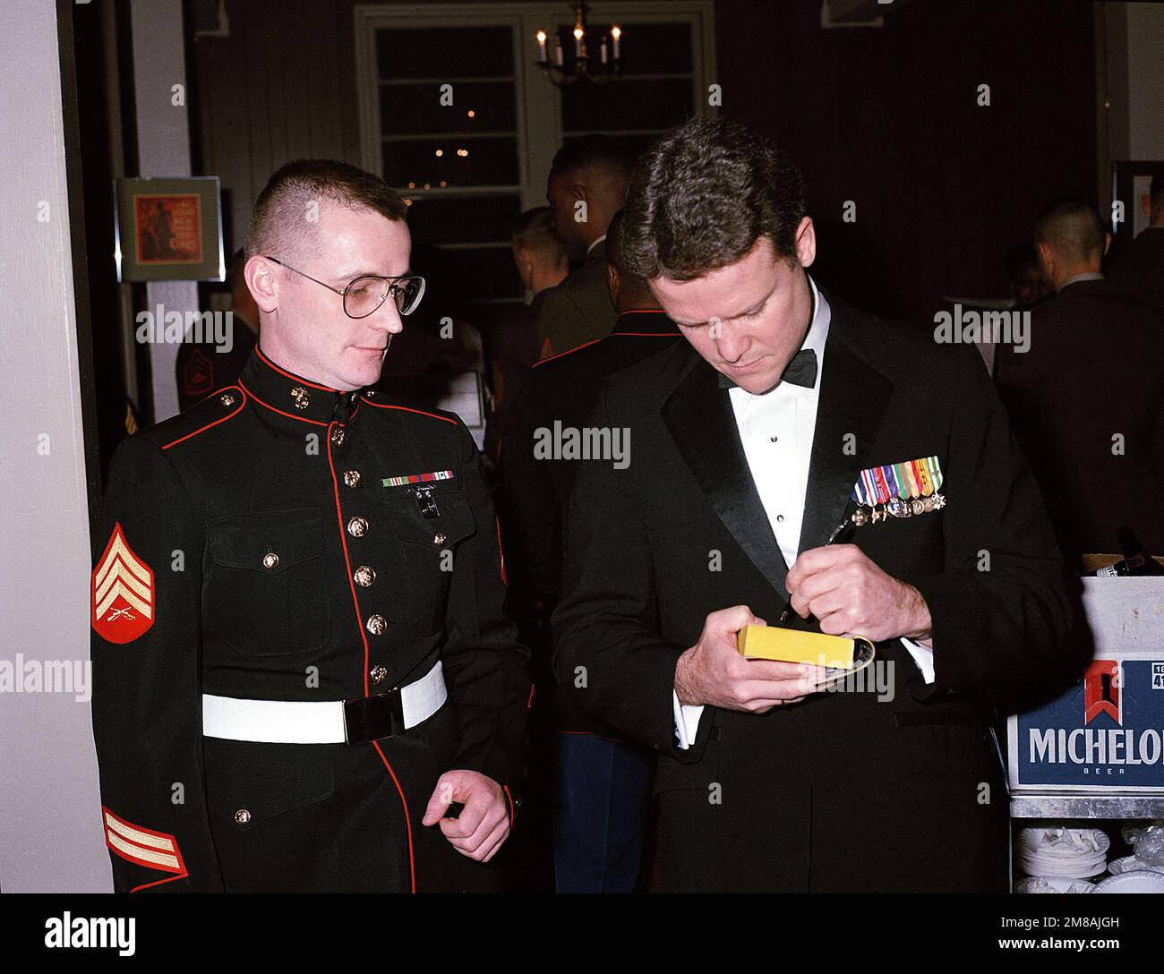 Secretary of the Navy James Webb signs an autograph during Mess Night ...