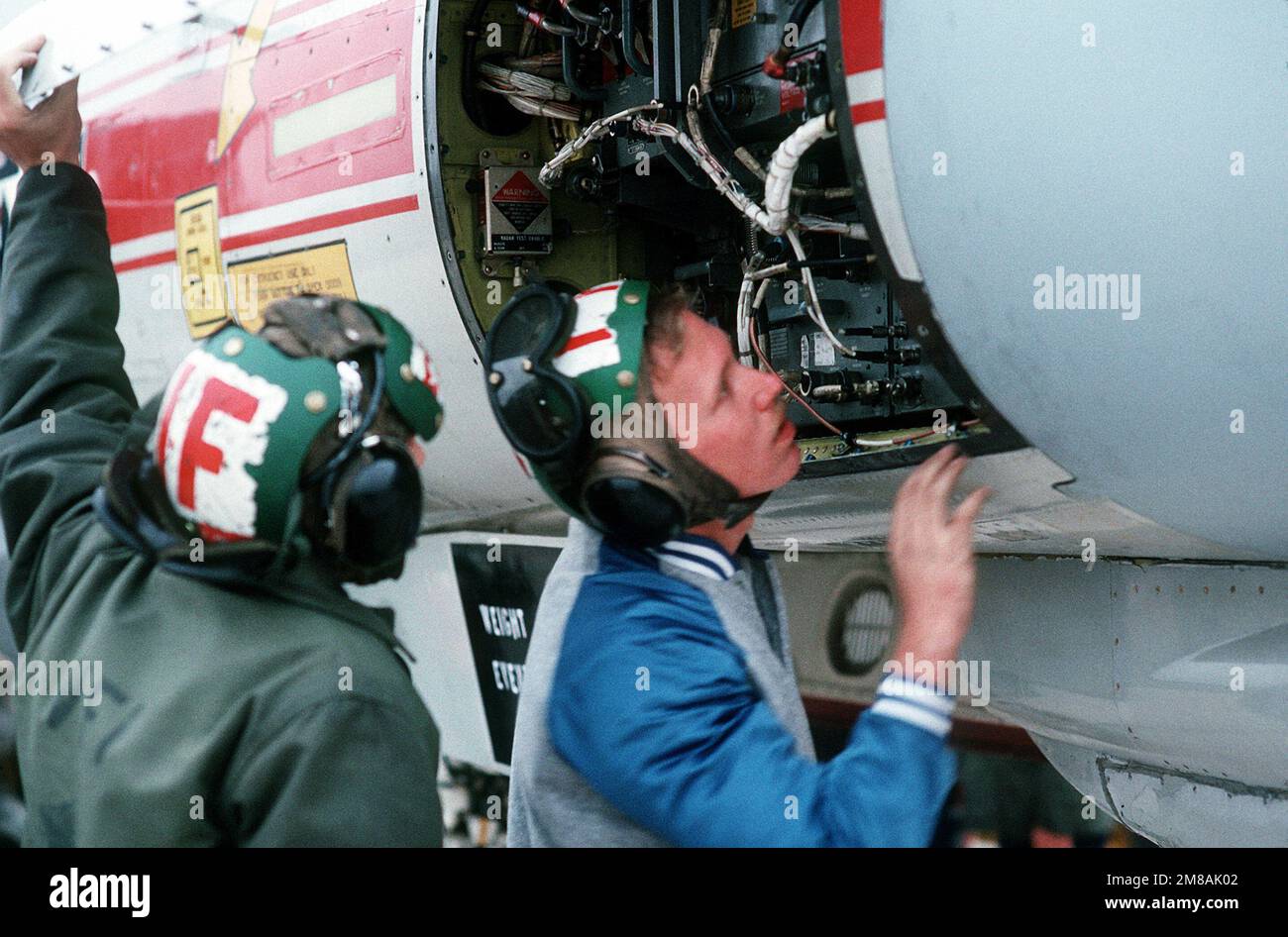 PH1 Paul Pappas Naval Air Station, Miramar....An ordnanceman attaches ...
