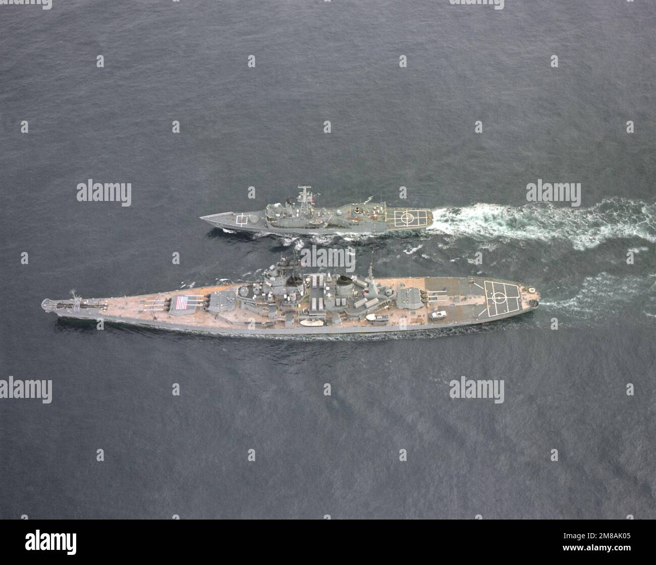 An overhead view of the battleship USS IOWA (BB-61) and the guided missile frigate USS ...