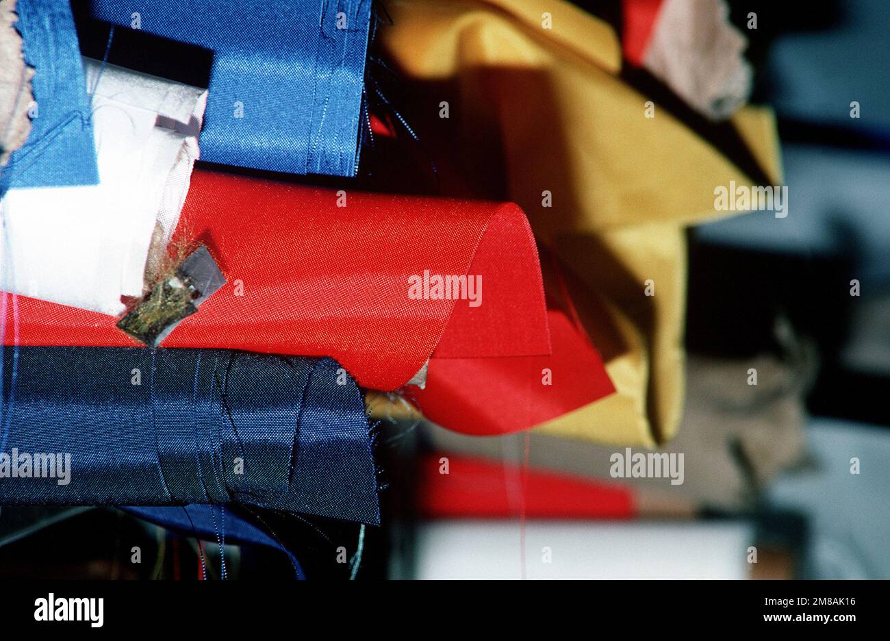 Swatches of brightly colored material wait to be made into signal flags ...
