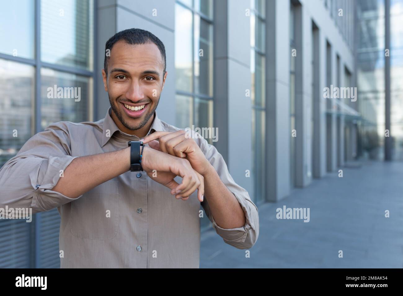 Latin American businessman in shirt cheerful talking with friends using ...