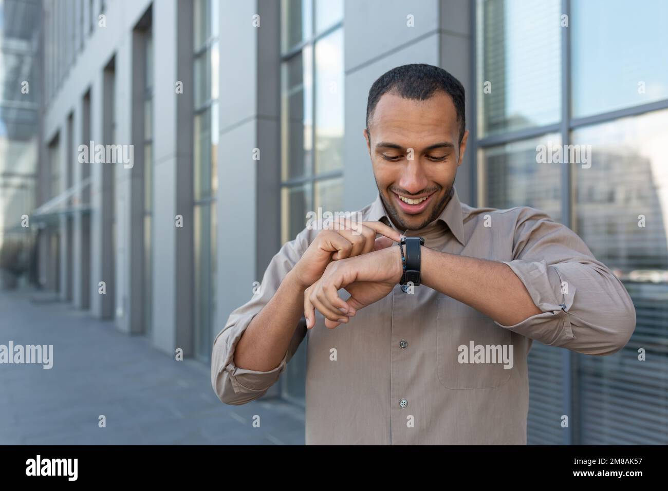 Latin American businessman in shirt cheerful talking with friends using ...