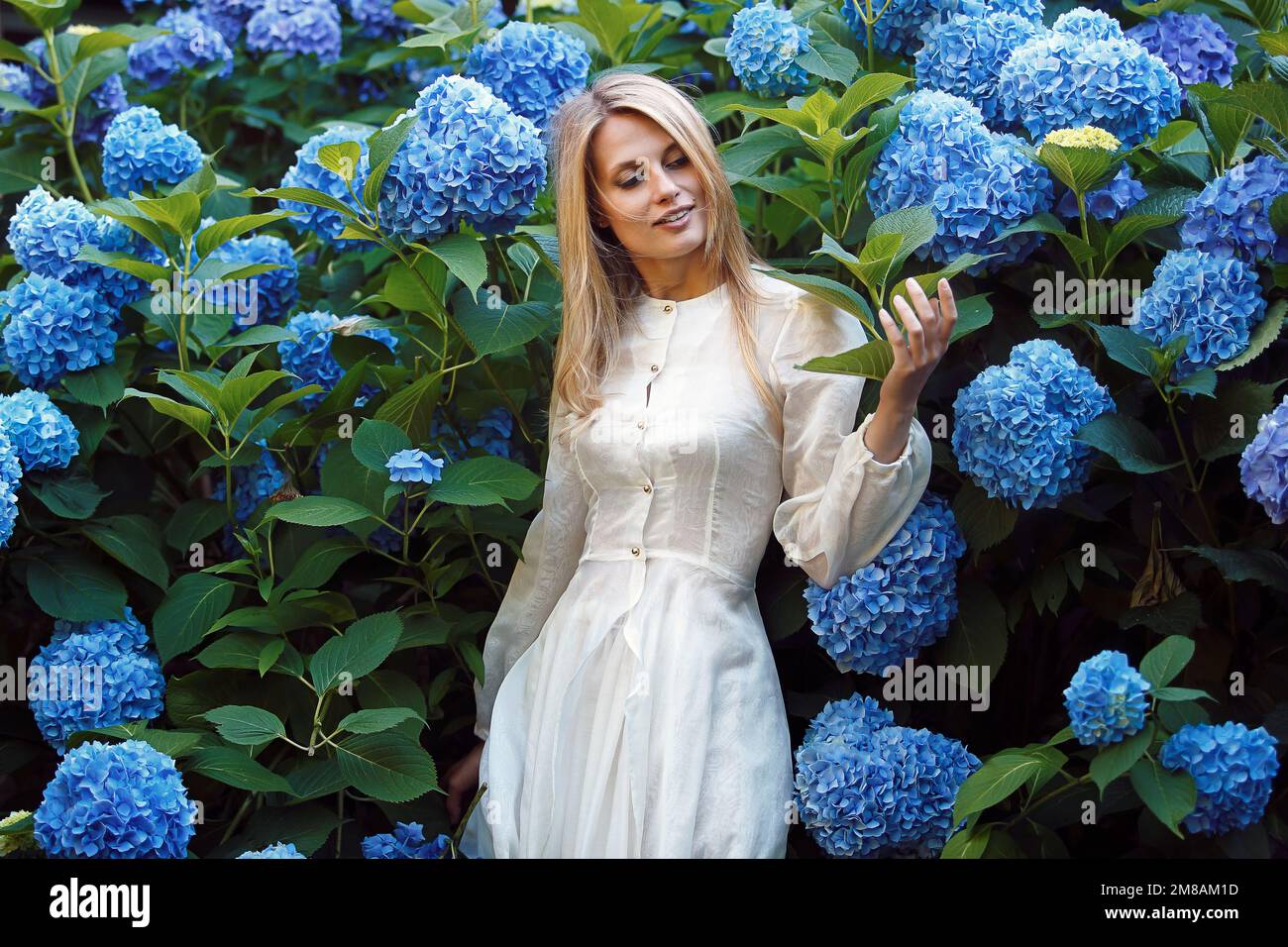 Beautiful vintage maiden in a flower garden Stock Photo - Alamy